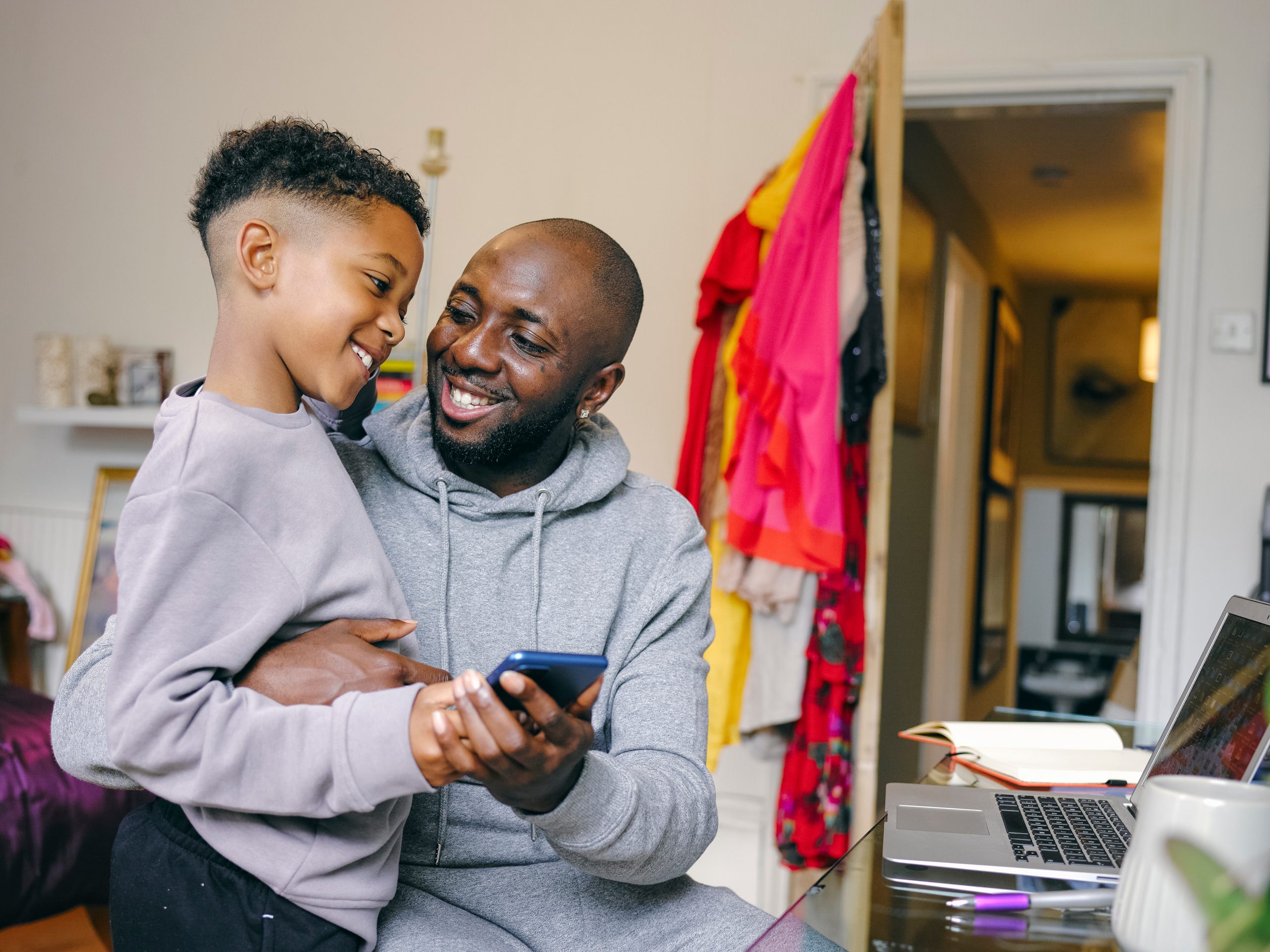 Father and son using phone at home | Children's Home Society of Virginia